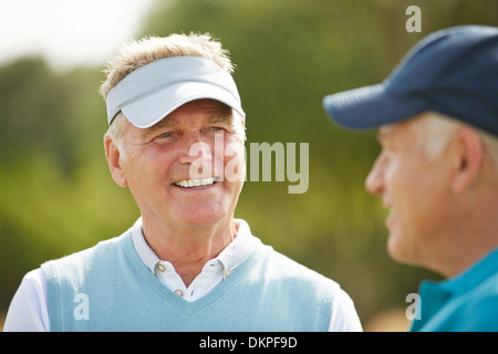Two golfers talking Stock Photo - Alamy