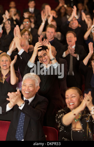 Enthusiastic theater audience clapping Stock Photo - Alamy