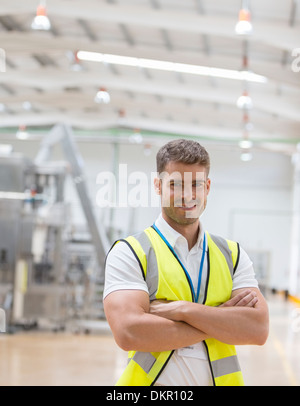 Smiling man working on factory Stock Photo - Alamy