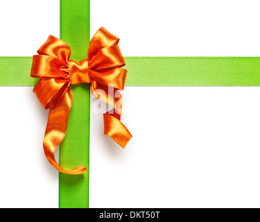 An orange ribbon tied on a green branch of a tree against the ...