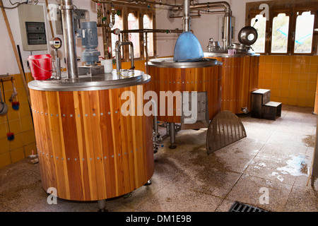 Bhutan, Choskhor Valley, Bumthang brewery, sticking label to bottle of ...