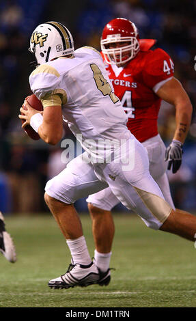 Central Florida quarterback Rob Calabrese is sandwiched between ...