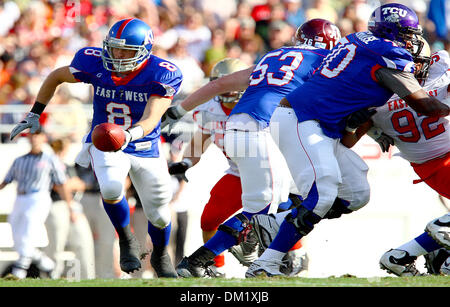 West team's quarterback Todd Reesing #8 is taken down by Greg Hardy Jr ...
