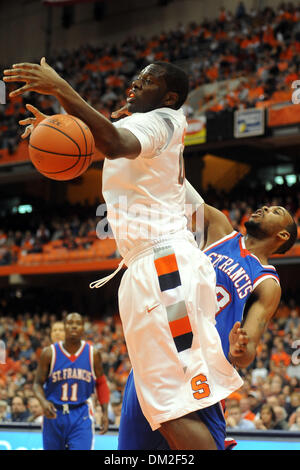 Syracuse forward Rick Jackson (middle) loses the ball after being ...