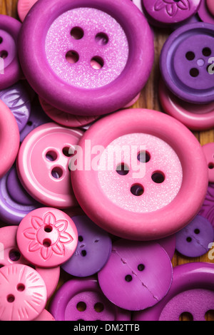 A lot of pink and purple sewing buttons closeup Stock Photo - Alamy