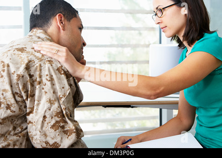 Military person having therapy session. Psychologist consults female ...