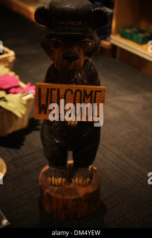 A wood carved bear holding a sign of Alaska welcome. Denali National ...
