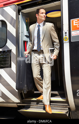 People getting off a train Stock Photo - Alamy