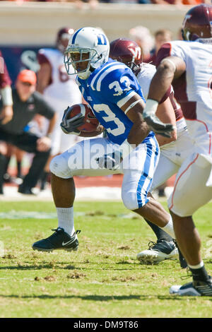 Duke running back Desmond Scott (33) is upended in the second quarter ...