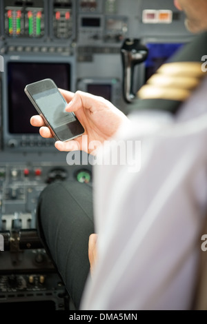 Pilot Using Cell Phone In Cockpit Stock Photo - Alamy