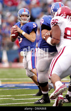Kansas quarterback Todd Reesing (5) looks to pass under heavy coverage ...