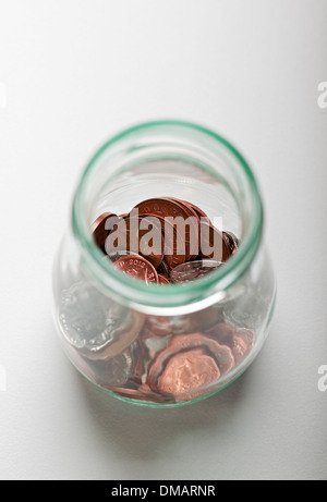 Coins in a jam jar Stock Photo - Alamy