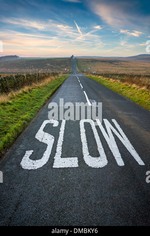 Road with slow sign perspective, distance, vanishing point Stock Photo ...