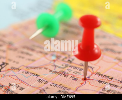 Pushpin pointing place on a paper map Stock Photo - Alamy