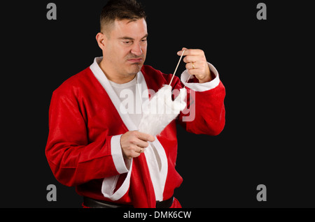 Guy getting ready to impersonate Santa, not very happy with his duty ...