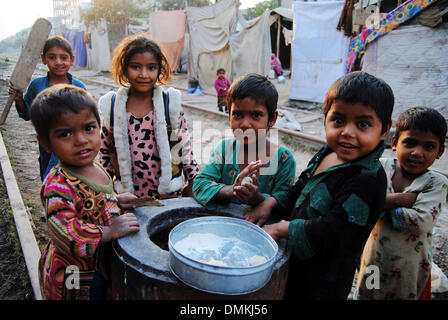Peshawar. 15th Dec, 2013. Pakistani children play near their makeshift ...