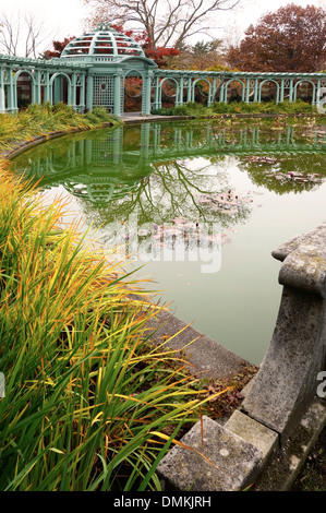 The ornamental fountain and green houses in the background at Eythrope ...