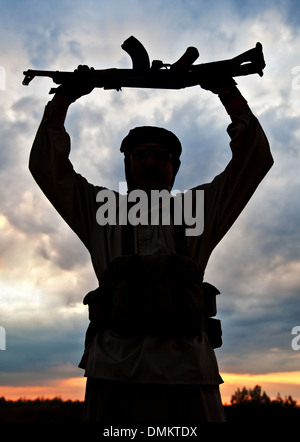 Silhouette of muslim militant with rifle Stock Photo - Alamy