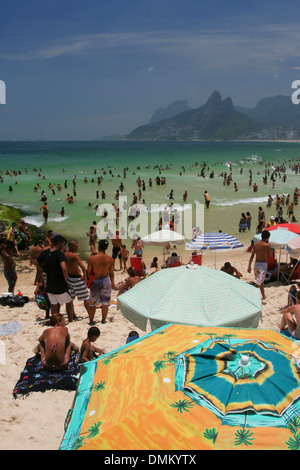 Sunbathers enjoy Arpoador Beach in a sunny spring afternoon. Rio de ...