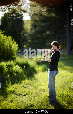 Lovely young woman plays the violin at home Stock Photo - Alamy