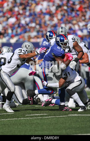 New York Giants #27 running back Brandon Jacobs gets pulled down by ...