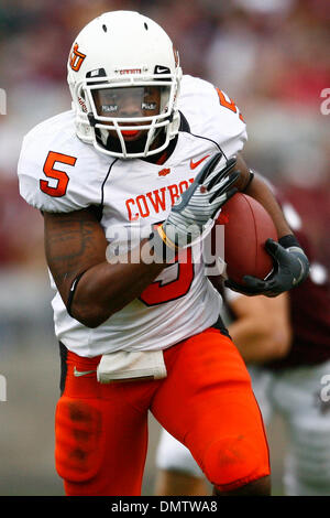 Keith Toston (#5) of the Oklahoma State University Cowboys slips past ...