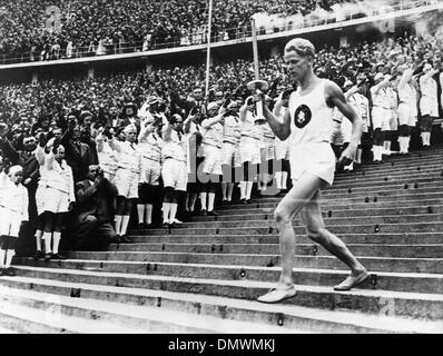 Aug. 2, 1936 - Berlin, Germany - A German athlete lighting the torch at ...