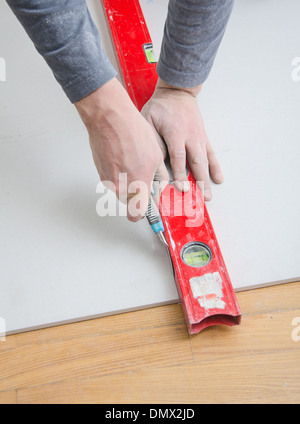 Construction worker cutting gypsum drywall by using electric cutter ...