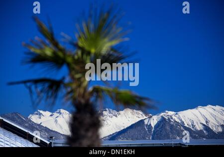 Sochi, Russia. 17th Dec, 2013. A vendor walks past an Olympic mascot in ...