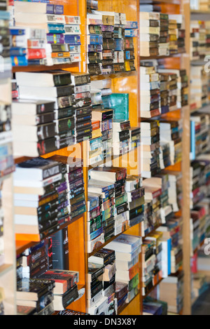shelves in a second hand book shop filled with books and more books on ...