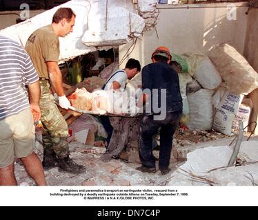 Sept. 8, 1999 - Athens, GRC - Firefighters and paramedics transport an ...