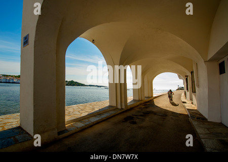 Evening light spills through an archway in the seaside town of Cadaques ...
