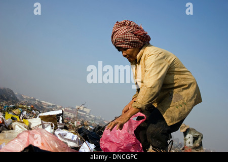 A woman scavenger is collecting recyclable material at the toxic Stung ...