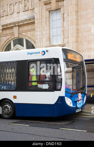stagecoach bus decorated as a seasonal santa bus picks up passengers in ...