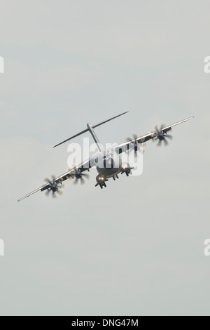 An Airbus A400M Atlas flies over military personnel taking part in an ...