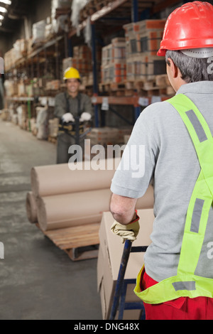 a warehouse manager pushing trolley Stock Photo - Alamy