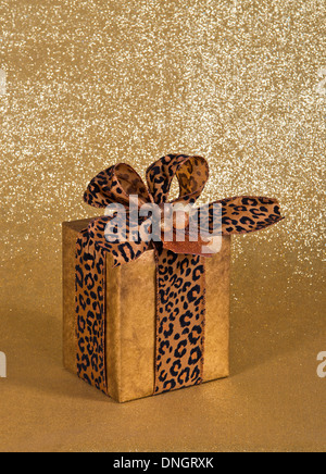 Present wrapped in glittery paper with red knot isolated on white Stock ...