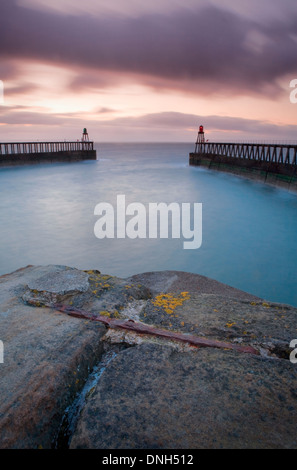 Sunset on the North Sea directly on the beach. Orange sky and low tide ...