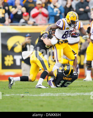Iowa defensive back John Lowdermilk (37) holds onto the legs of ...