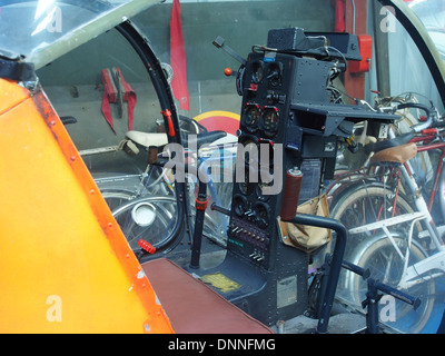 This image shows the cockpit of a Bell 47 helicopter, displayed at the ...