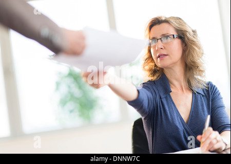 Business people exchanging documents Stock Photo - Alamy