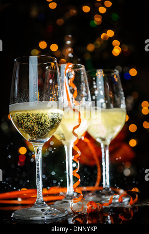 Champagne pouring into three party glasses Stock Photo - Alamy