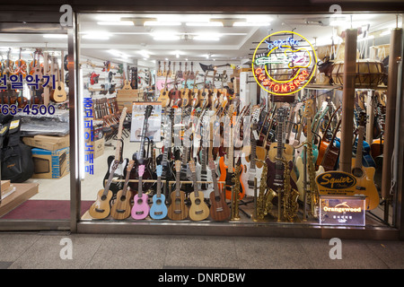 Guitars on display at music store Stock Photo - Alamy