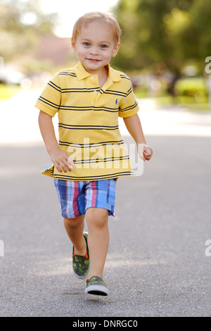 Kid running in summer street. Child enjoy run. Little boy running on ...