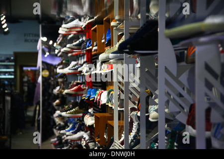Racks of trainers on display in a sports store Stock Photo - Alamy