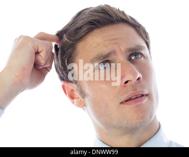 Thinking businessman scratching head Stock Photo - Alamy