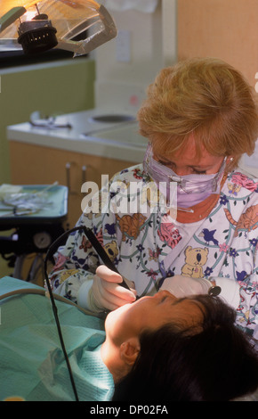 Female dentist with dental tools on blue background. World Dentist Day ...