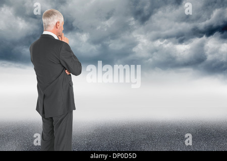 Composite image of thoughtful businessman standing back to camera Stock ...