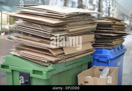 Garbage cans with paperboard are staying on the street to get picked up ...