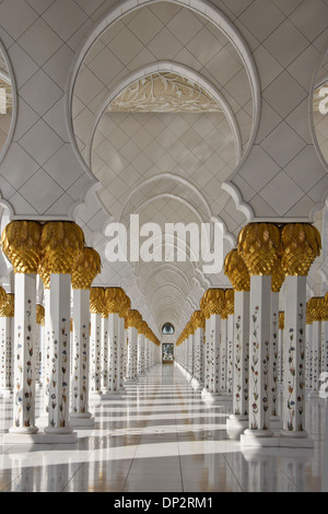 Gilded white marble columns with mosaic of multicolored stones in form ...